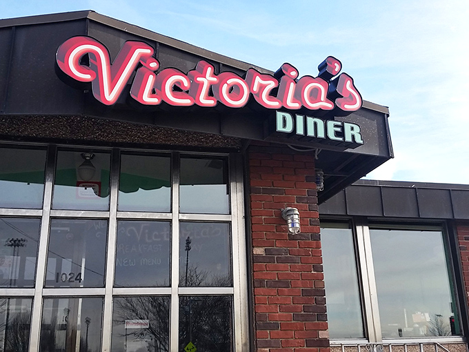 Victoria's neon sign beckons hungry travelers like a lighthouse guiding breakfast-seekers to safe, delicious harbor.