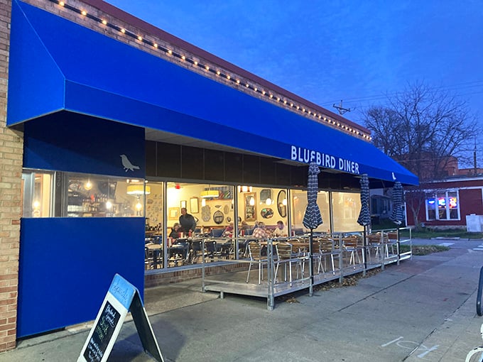 Bluebird Diner: As evening falls, this Iowa City gem transforms. The warm glow from inside hints at late-night breakfast miracles waiting to happen.