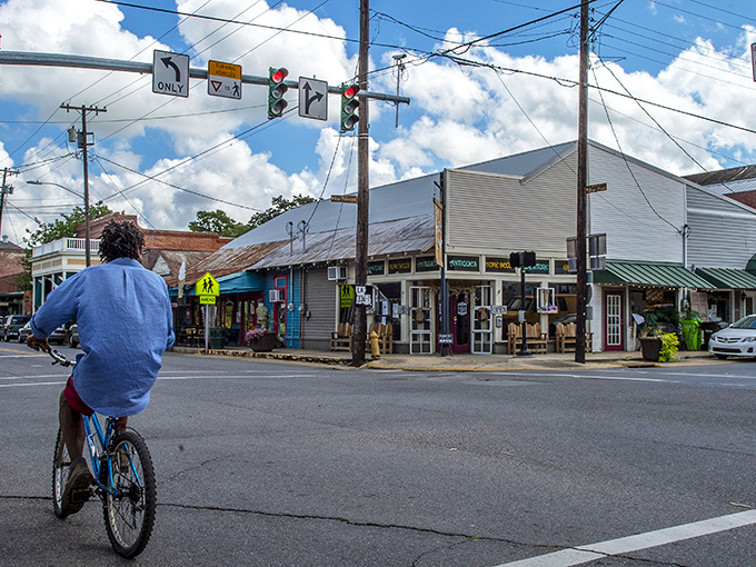 A cyclist navigates the crossroads of charm and authenticity in downtown Breaux Bridge, where locals still greet you by name.