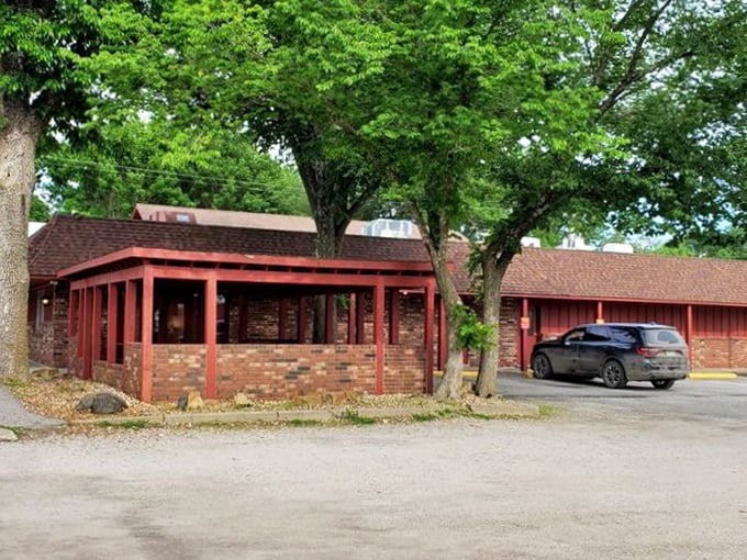 Trees provide shade for the steady stream of cars pulling up to Chicken Mary's, where the great chicken debate of Kansas continues daily.