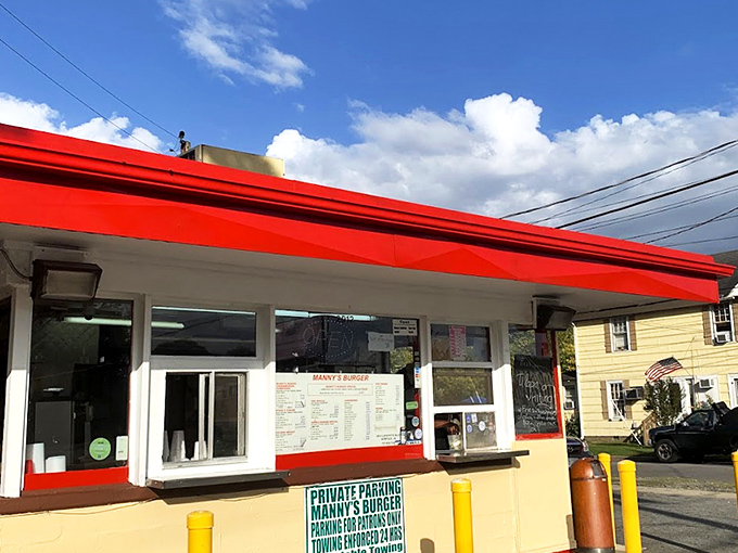 Order window simplicity at its finest. Manny's red awning serves as a beacon to burger pilgrims seeking hand-crafted delights without the fancy frills.