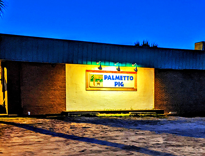 Night falls, but Palmetto Pig's sign glows like a beacon. Your stomach's lighthouse in a sea of mediocre meals.
