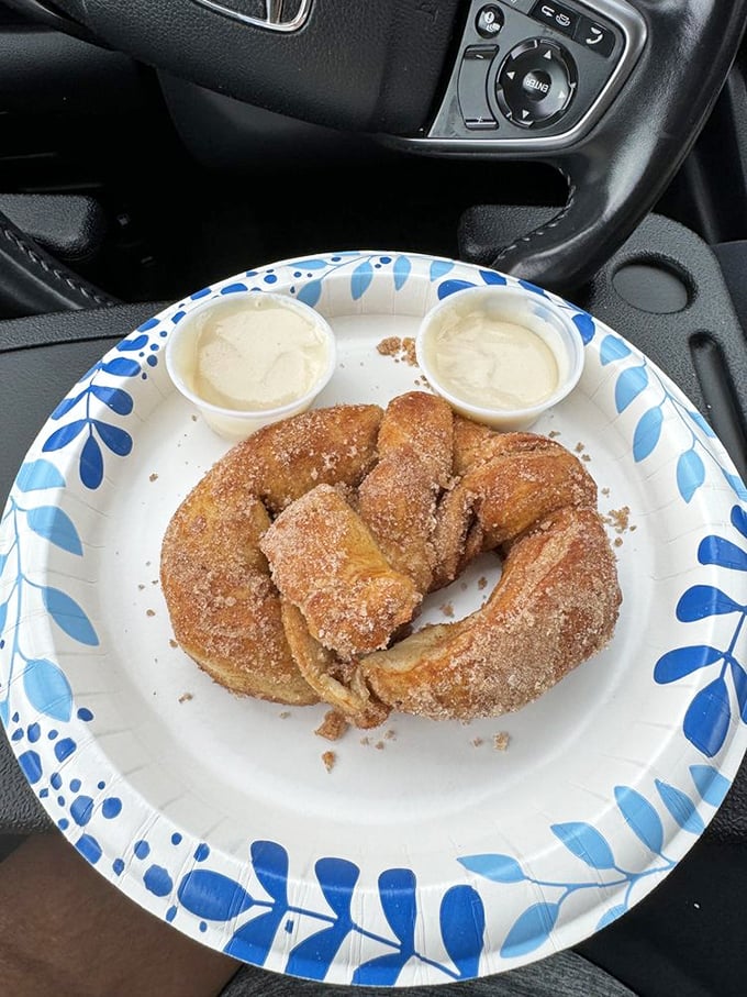 This isn't just a pretzel - it's a buttery, sugar-dusted revelation served with dipping sauce that'll make you question all other snacks.