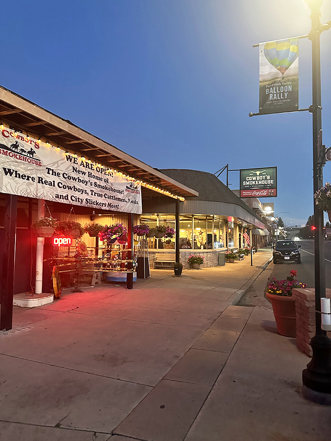 Cowboy's Smokehouse isn't just dinner; it's theater. The neon "OPEN" sign is your invitation to a smoky, meaty performance that's been perfecting its run for decades.