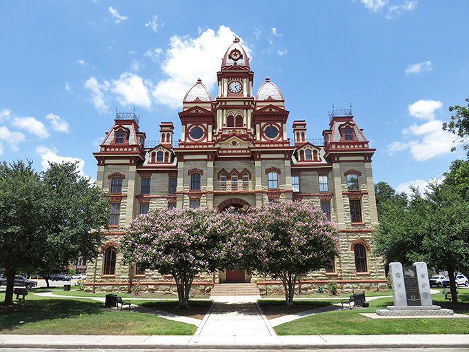 The Caldwell County Courthouse stands like a Victorian grande dame, keeping watch over Lockhart with ornate dignity and architectural splendor.