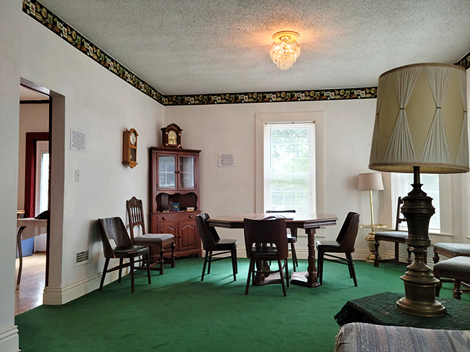 The dining room's vintage decor and period furniture create an atmosphere frozen in time. That green carpet has witnessed decades of unexplained phenomena.