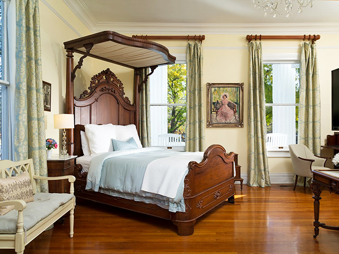 A four-poster bed that whispers, "Go ahead, sleep in tomorrow." Sunlight streaming through those windows is nature's gentlest alarm clock.