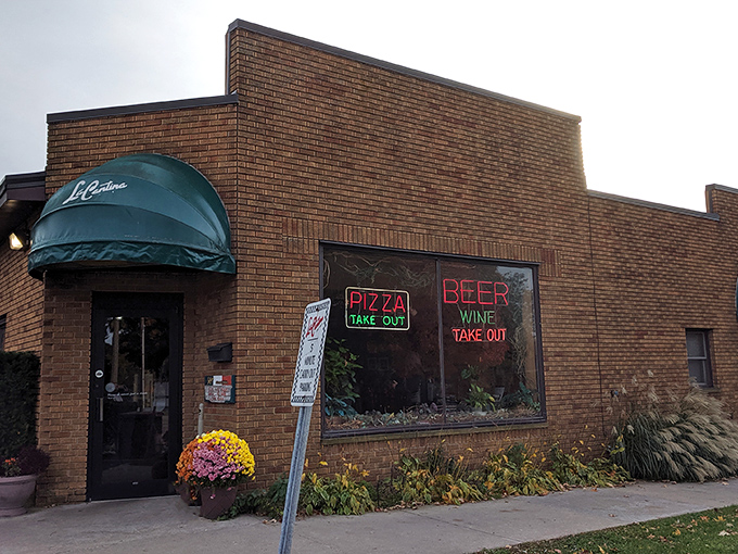 La Cantina's unassuming brick exterior hides a culinary treasure within. The neon signs promise simple pleasures &ndash; pizza, beer, wine &ndash; what more could you need?