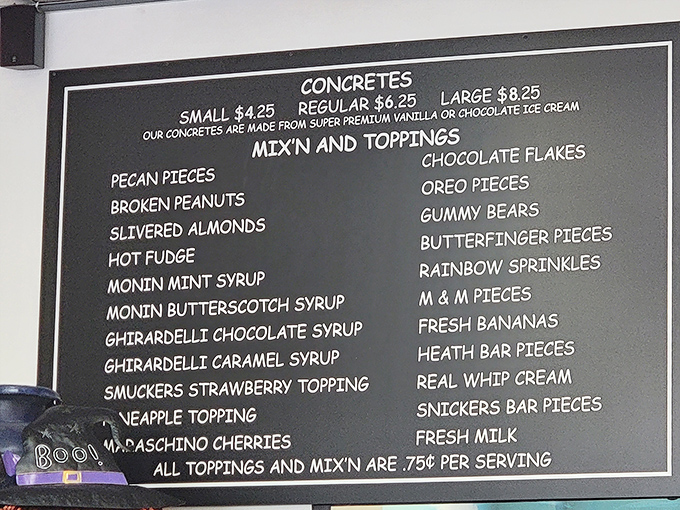 The menu board at Scoops reads like poetry for dessert lovers. Each topping possibility represents a different path to happiness.