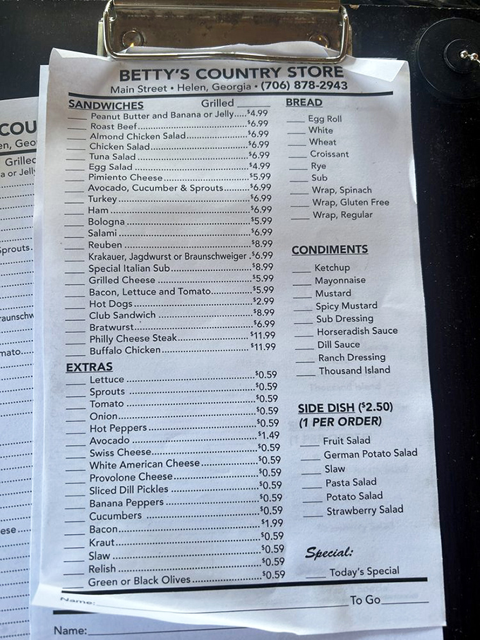 The menu board—a roadmap to happiness. Each handwritten item represents not just a sandwich but a promise of mountain-made perfection awaiting your order.