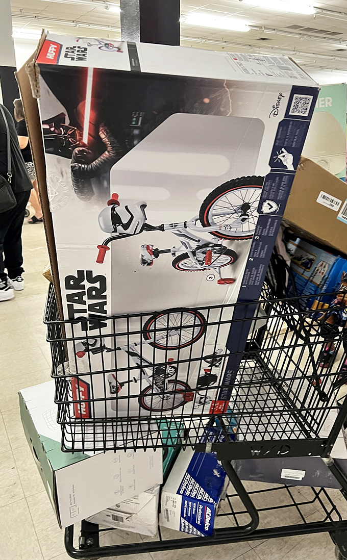 A Star Wars bicycle in a shopping cart—proof that the Force is strong with bargain hunters who arrive early enough to score galactic deals.