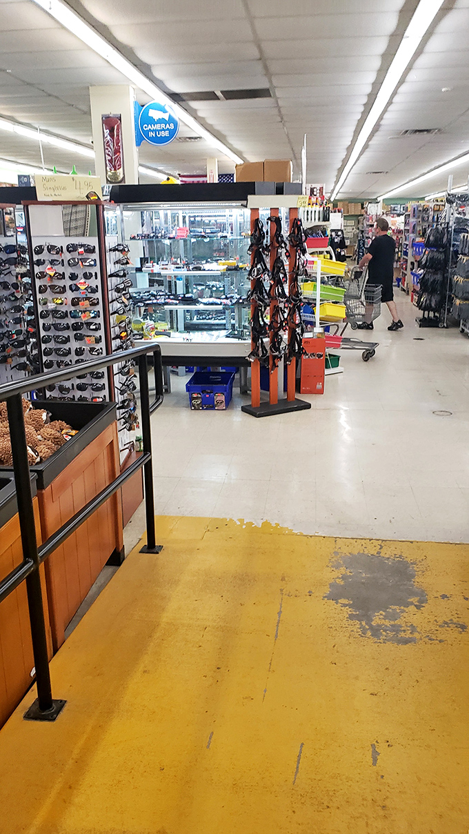 The sunglasses display stands guard near the jewelry counter, where shoppers can find accessories that look expensive but aren't. Win-win!