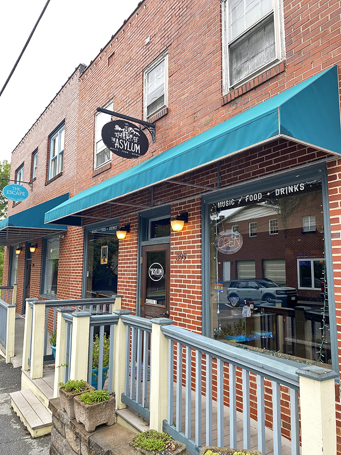 The Asylum's turquoise awning signals a sanctuary for food lovers, where brick walls and wooden railings frame culinary revelations.