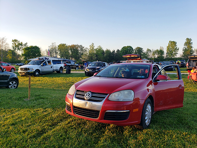 Modern vehicles arranged in neat rows, their owners creating little nests of comfort&mdash;drive-in culture's beautiful evolution from the tailfin era.