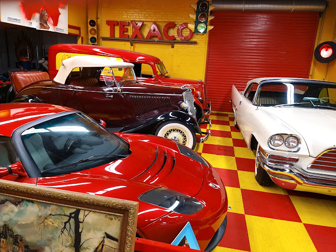 Classic cars share space with nostalgia in this wonderland of Americana. The checkered floor screams "1950s diner" while the vehicles whisper "timeless cool."