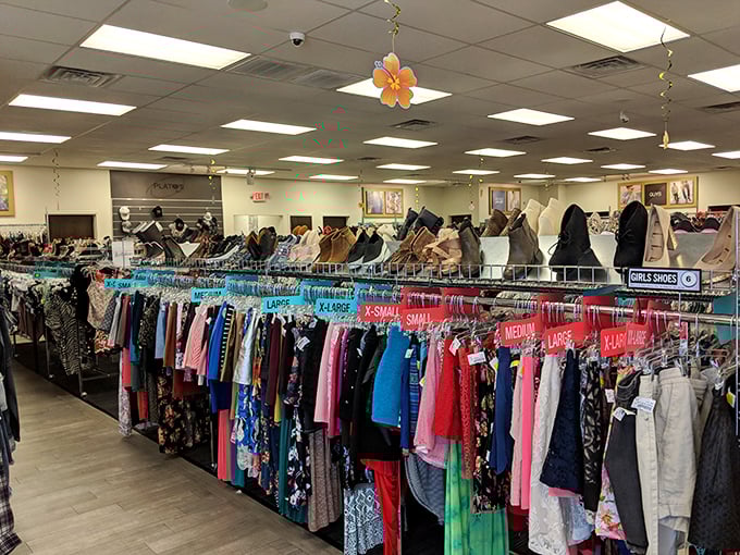 The women's section bursts with color-coded possibilities, where yesterday's trends await their second chance at stylish life.