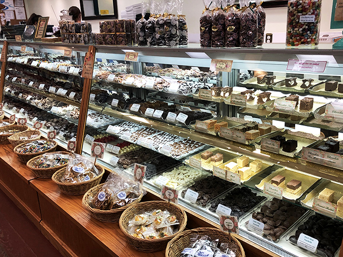 This display case isn't just showcasing treats &ndash; it's showcasing memories waiting to happen. Each chocolate square promises a moment of pure bliss.