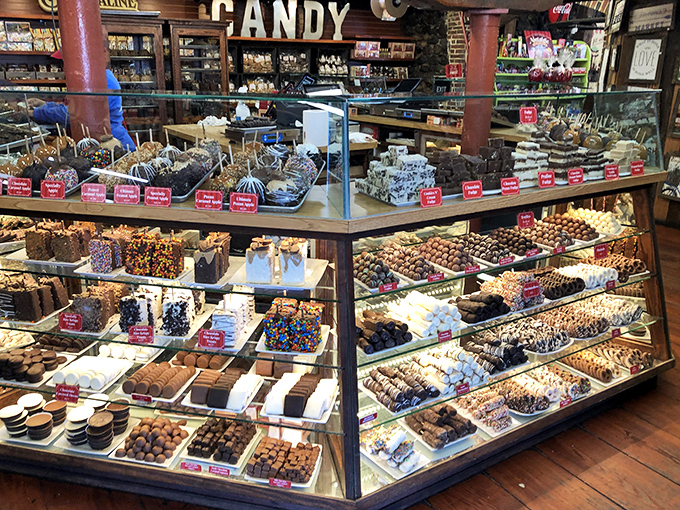 This isn't just a display case&mdash;it's an edible art gallery where pralines, fudge, and chocolate-dipped everything compete for your attention and willpower.