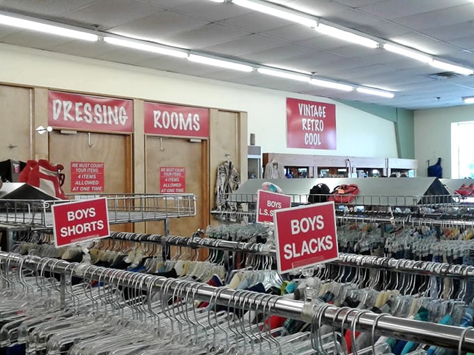 "Vintage Retro Cool" isn't just a sign—it's a promise. The boys' clothing section demonstrates the meticulous organization that makes treasure hunting manageable.