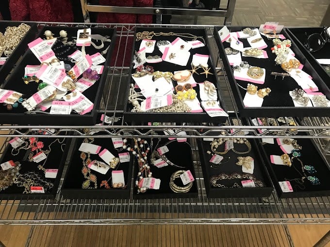 The jewelry counter—where costume pieces and potential heirlooms coexist in trays of organized chaos, waiting for their second act on someone's dresser.