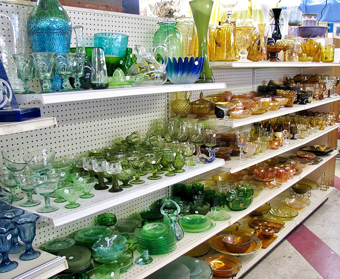 The glassware section sparkles with decades of colorful history&mdash;from Depression-era green to mid-century amber, each piece whispering stories of dinner parties past.