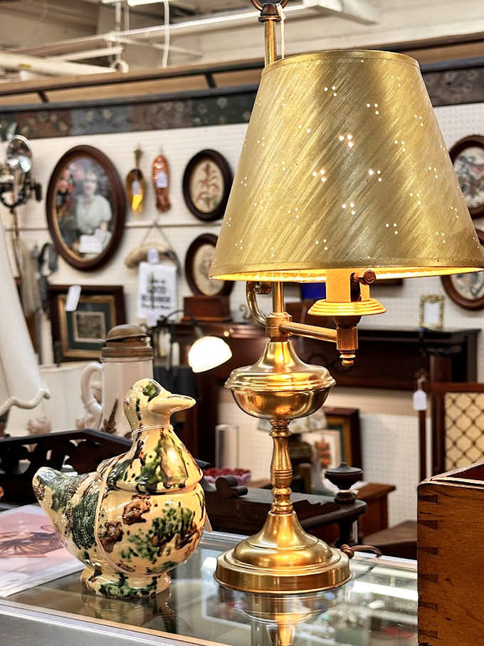 This elegant brass lamp and ceramic duck might have never met before landing here, like characters from different movies sharing a scene.
