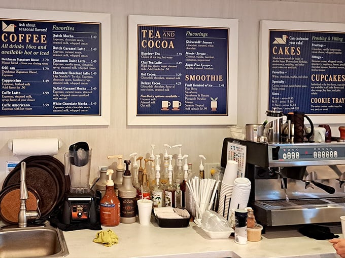 Coffee, tea, and temptation. The bakery counter menu board promises caffeinated delights to complement your inevitable pie selection.