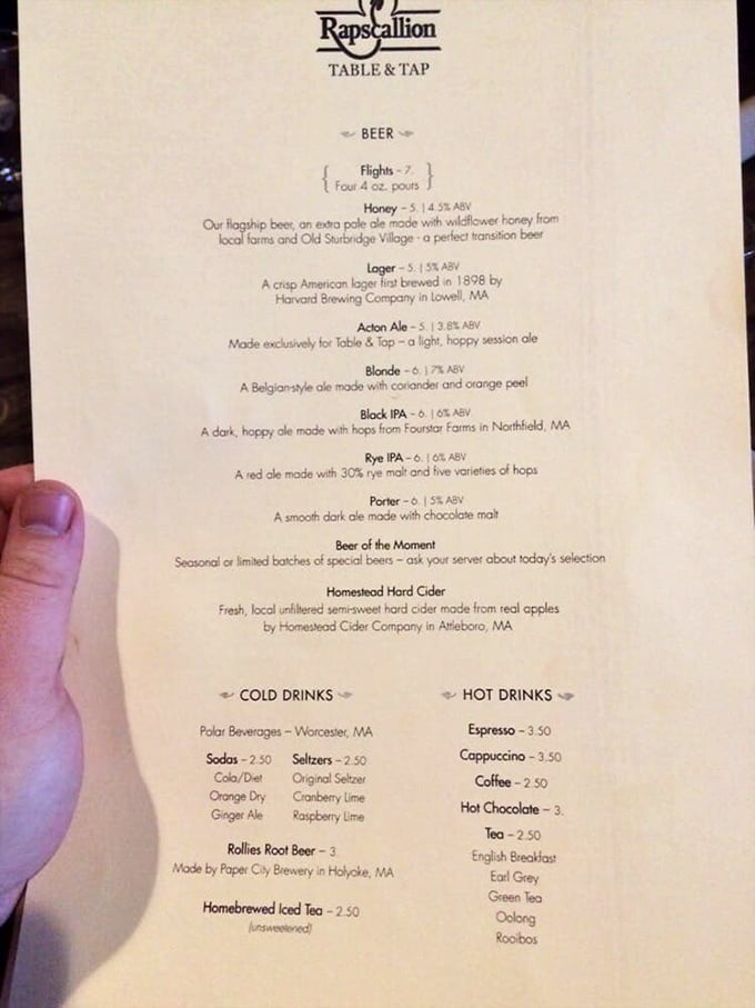 The drink menu reveals Rapscallion's local commitment, featuring their signature root beer crafted by Paper City Brewery&mdash;a beverage pilgrimage worth every mile.