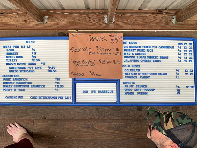 The menu board speaks a language all BBQ lovers understand: meat by the pound, handhelds for the impatient, and sides that refuse to be overshadowed.