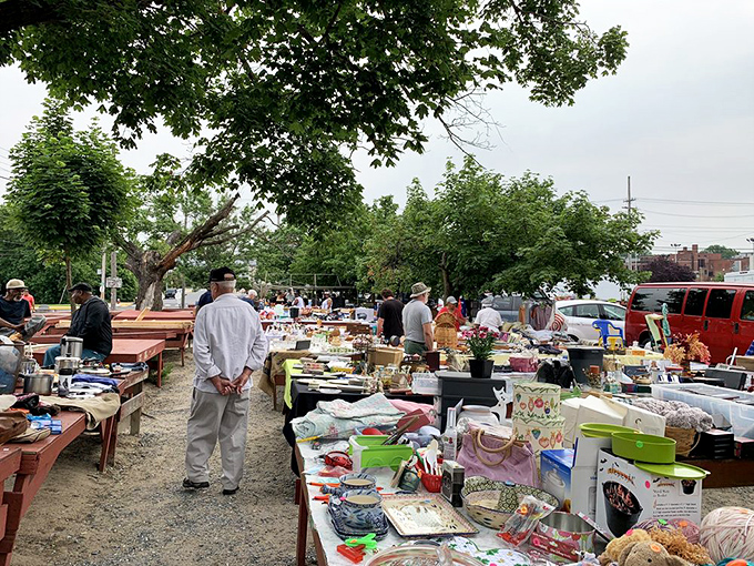 The outdoor market transforms into a community gathering spot where strangers become temporary neighbors united in the thrill of the hunt.