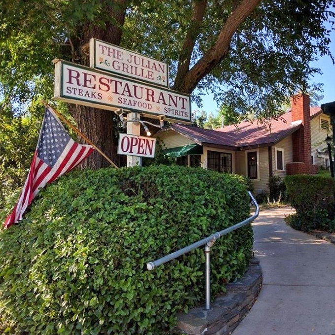 The Julian Grille promises steaks, seafood, and spirits beneath a canopy of trees. American flag included, patriotism optional but encouraged.