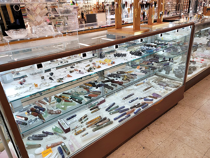 This glass cabinet houses a geological wonderland where crystal wands and mineral specimens await their perfect mystical match.