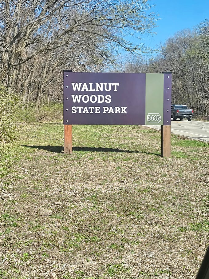 Not all who wander are lost, but this sign helps anyway. Walnut Woods State Park welcomes visitors with the promise of natural wonders just beyond.