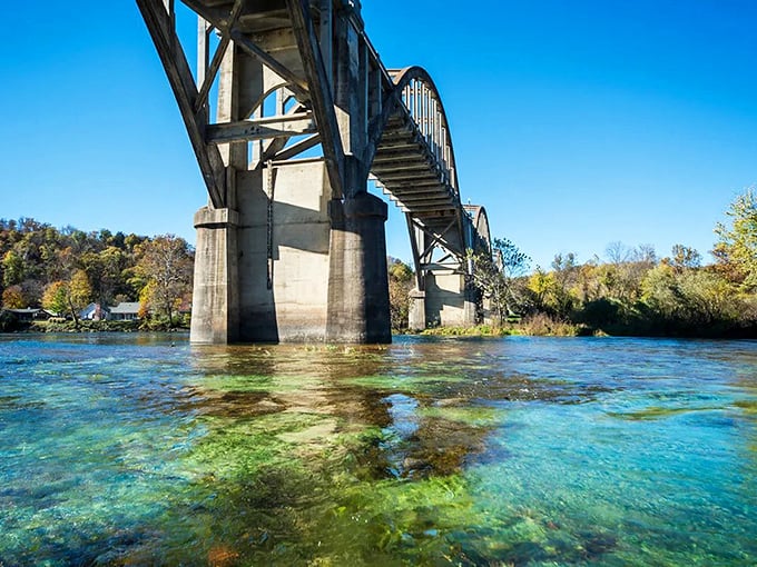 Crystal waters reveal the bridge's secret reflection, where concrete meets clarity. The White River doesn't just flow under&mdash;it showcases the bridge's majesty.
