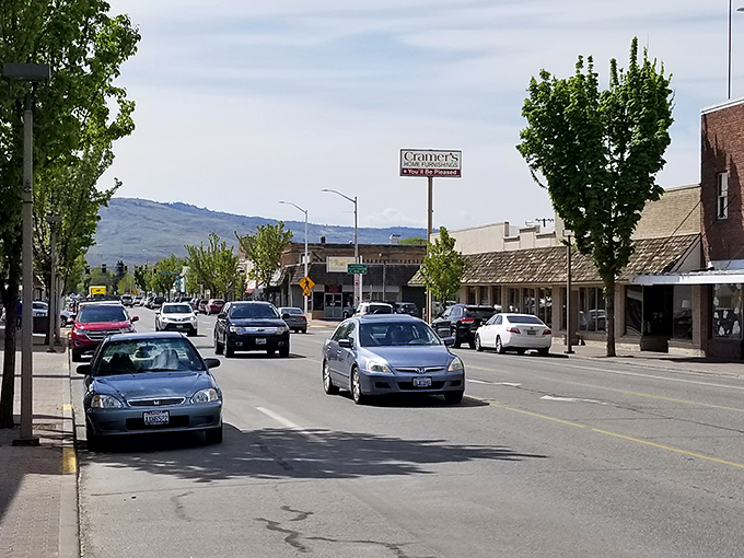 Omak's downtown stretches beneath rolling hills, where local businesses welcome visitors with small-town friendliness.