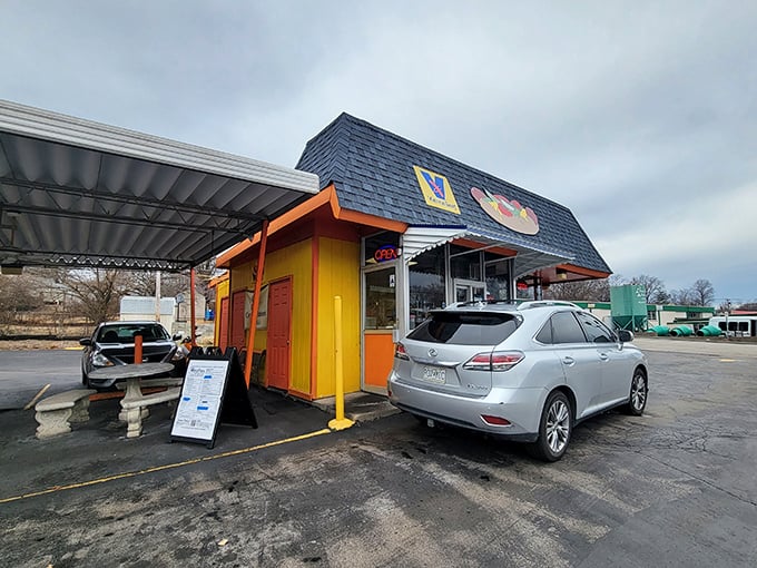 Woofie's vibrant yellow-and-orange stand pops against the gray parking lot&mdash;a colorful promise of deliciousness to come.