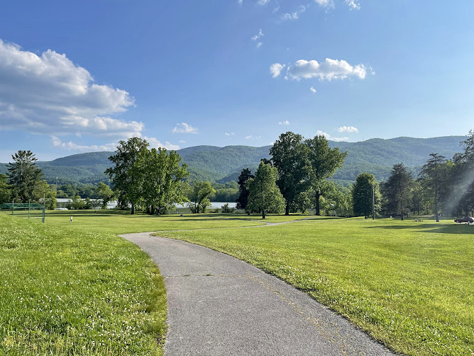 Mountains gather around Cove Lake like old friends sharing stories, their reflections rippling with each passing breeze.