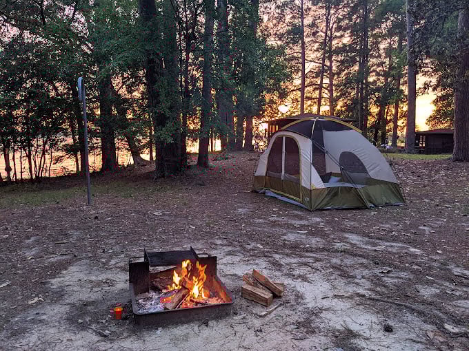 Martin Dies Jr. State Park: A camper's dream with fire, tent, and sunset&mdash;just add marshmallows and ghost stories for peak outdoor bliss.