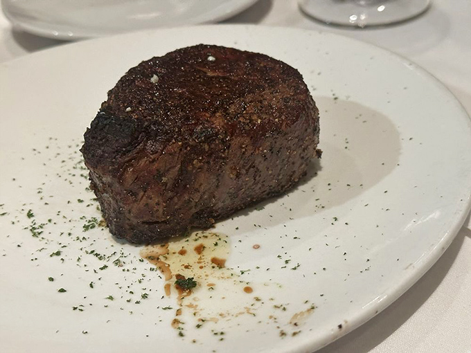 Behold the star of the show! This filet mignon sits on its white throne like royalty, perfectly seasoned and seared to a magnificent crust.
