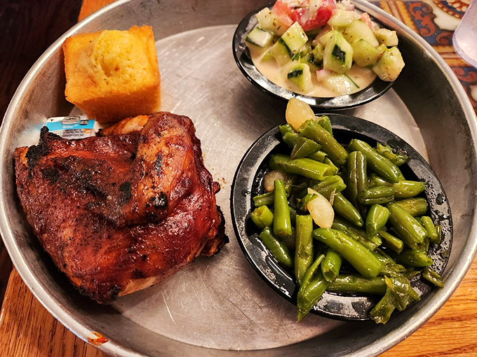 Smoke-kissed chicken with that perfect mahogany sheen, flanked by green beans and cornbread. This bird didn't fly south for nothing.