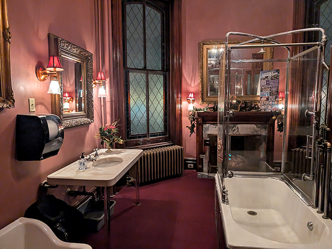 Victorian luxury meets modern amenities in this ornate bathroom. That shower enclosure looks like it could double as a time machine to the Gilded Age.