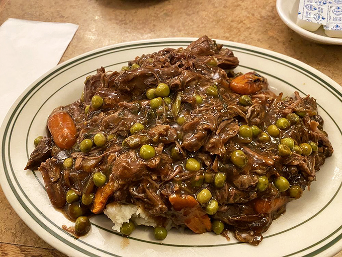 This isn't just pot roast&mdash;it's a tender surrender of beef that's been negotiating with gravy, carrots, and peas for hours. The meat lost deliciously.