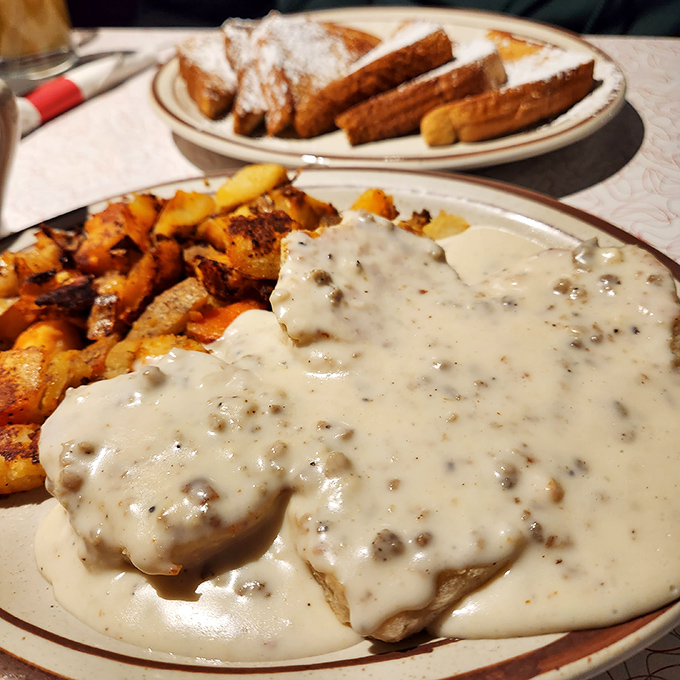 Biscuits and gravy that doesn't whisper but announces itself &ndash; a creamy, peppery blanket that transforms ordinary potatoes into breakfast royalty.