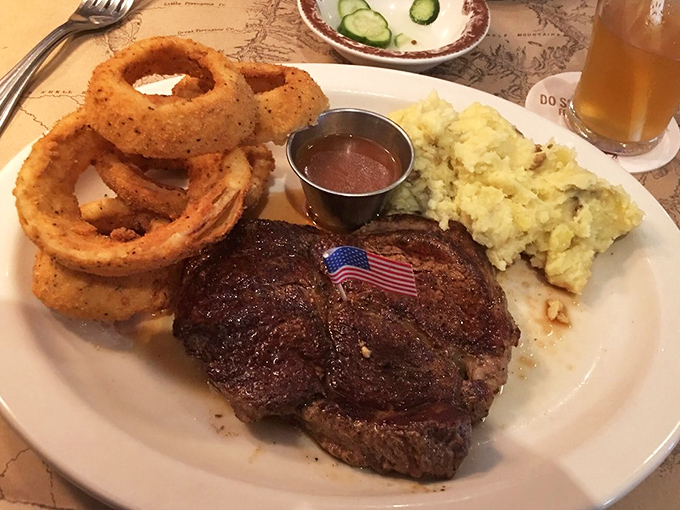 That moment when your steak arrives with its own tiny American flag&mdash;patriotism never tasted so good. The onion rings and mashed potatoes aren't mere sides; they're supporting actors deserving their own spotlight.