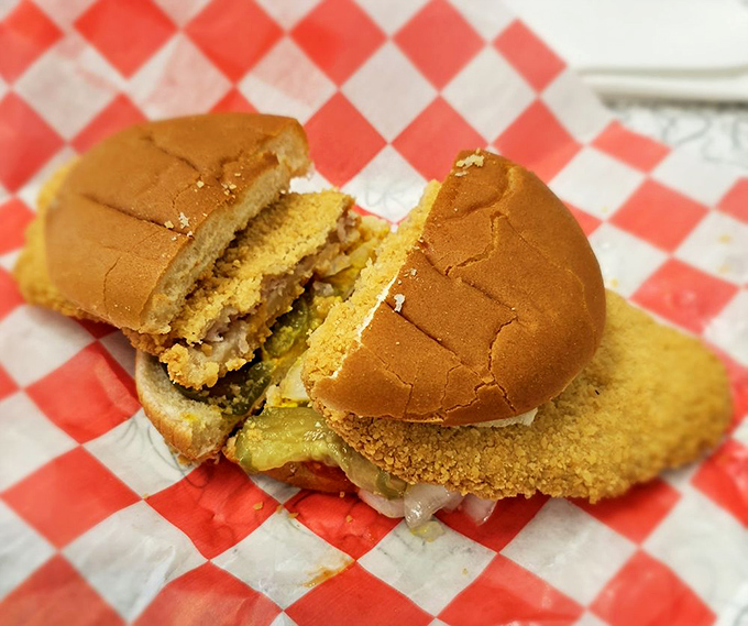 The architectural marvel of Iowa cuisine&mdash;a golden-brown disk of perfectly fried pork with a bun playing the role of a tiny hat. Structural engineering meets culinary art.
