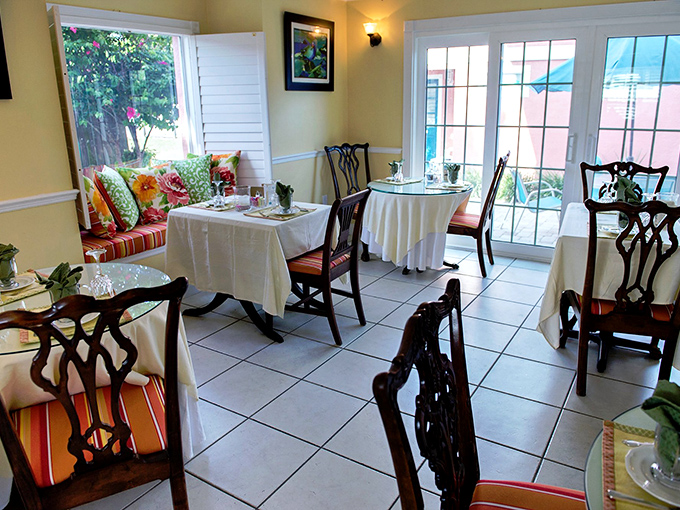 Breakfast with a view: The sunny dining area combines elegant table settings with casual Florida charm, making morning meals feel like the special occasion they should be.