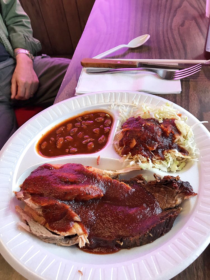 Behold the holy trinity: smoky brisket with that telltale pink ring, beans that have clearly been taking notes, and slaw for that perfect textural counterpoint.