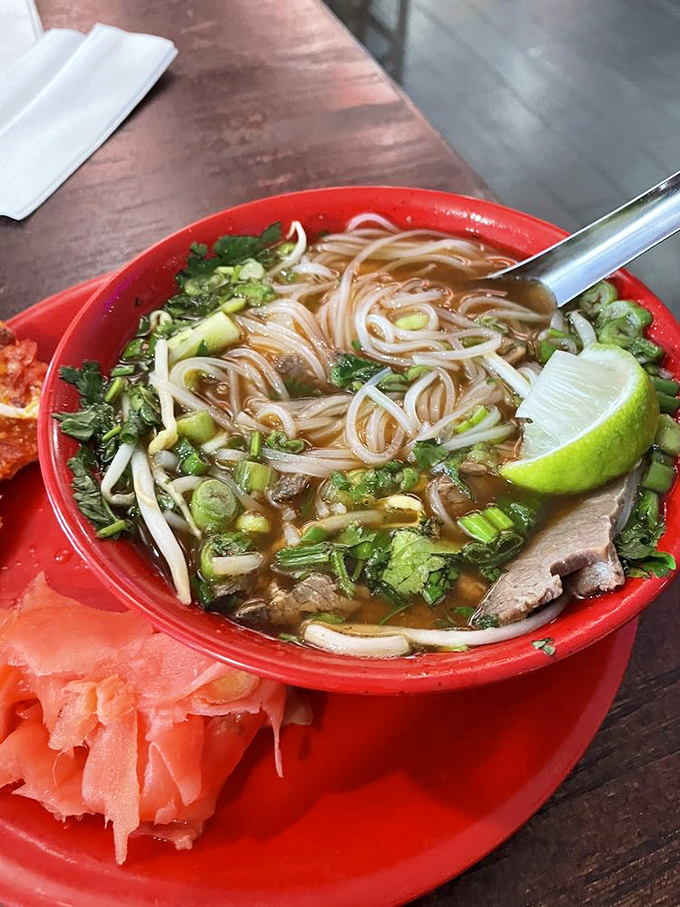 This isn't just pho&mdash;it's a steaming bowl of redemption. Fresh herbs, tender meat, and that lime wedge waiting to unleash its citrus magic.