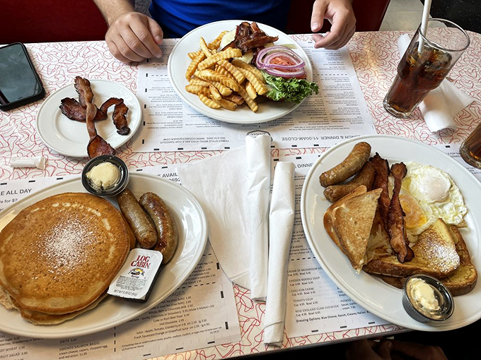 Breakfast spread that would make Ron Swanson weep with joy. That pancake is the size of a frisbee, and nobody's complaining about it.