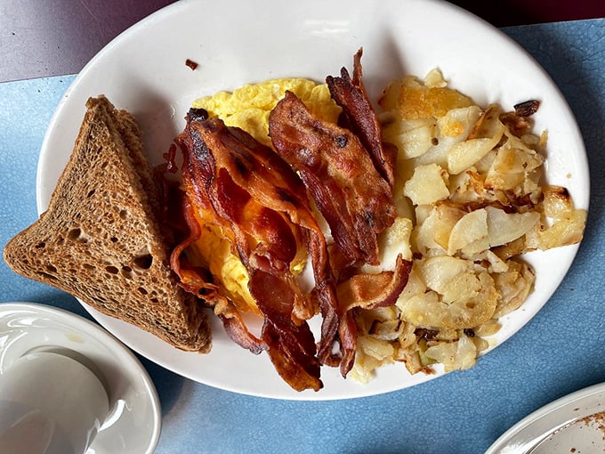 Breakfast perfection doesn't need fancy plating. Just eggs, bacon, home fries, and toast&mdash;the four food groups of morning happiness.